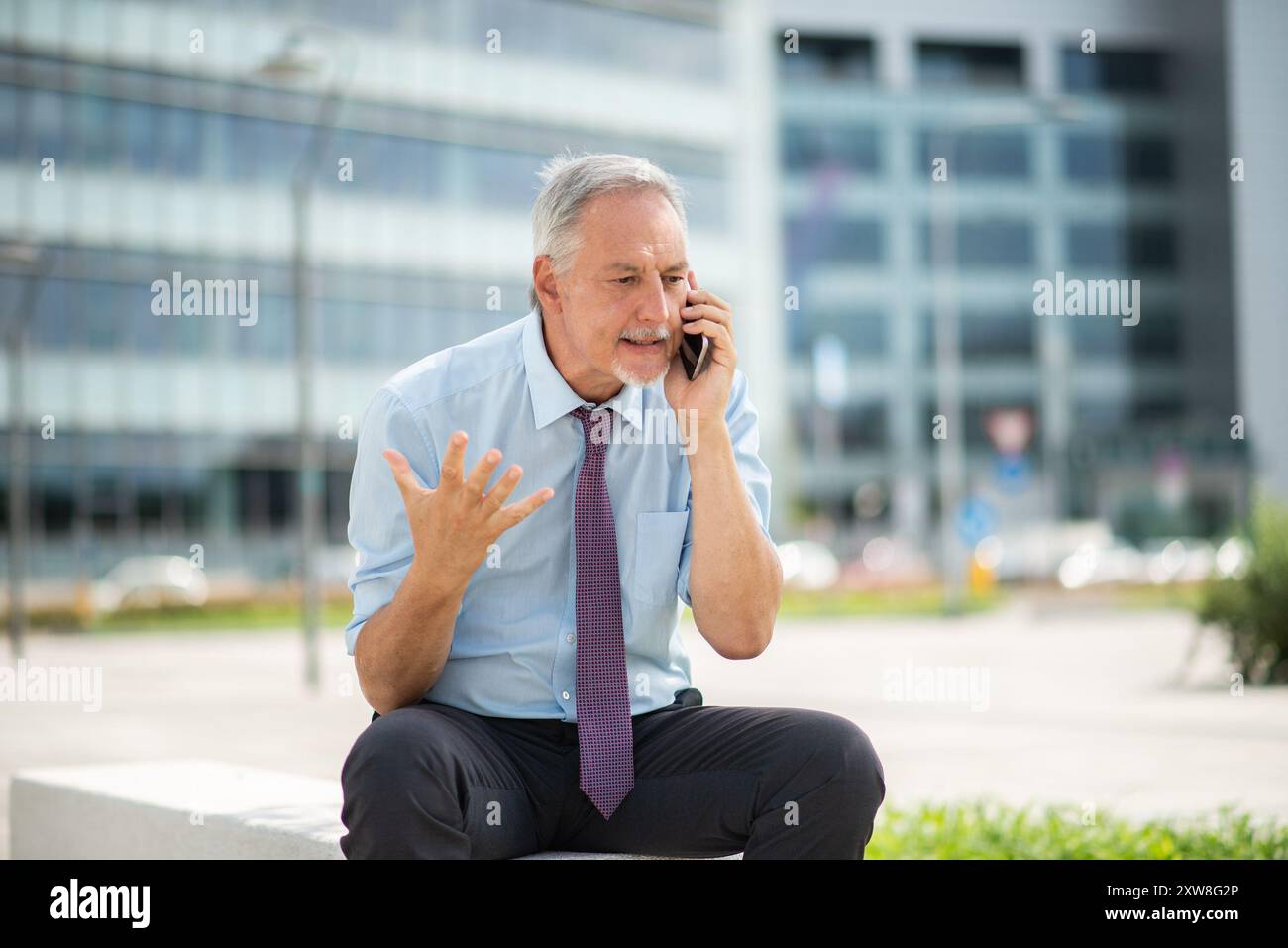 Angry senior business man yelling at the phone outdoor Stock Photo - Alamy