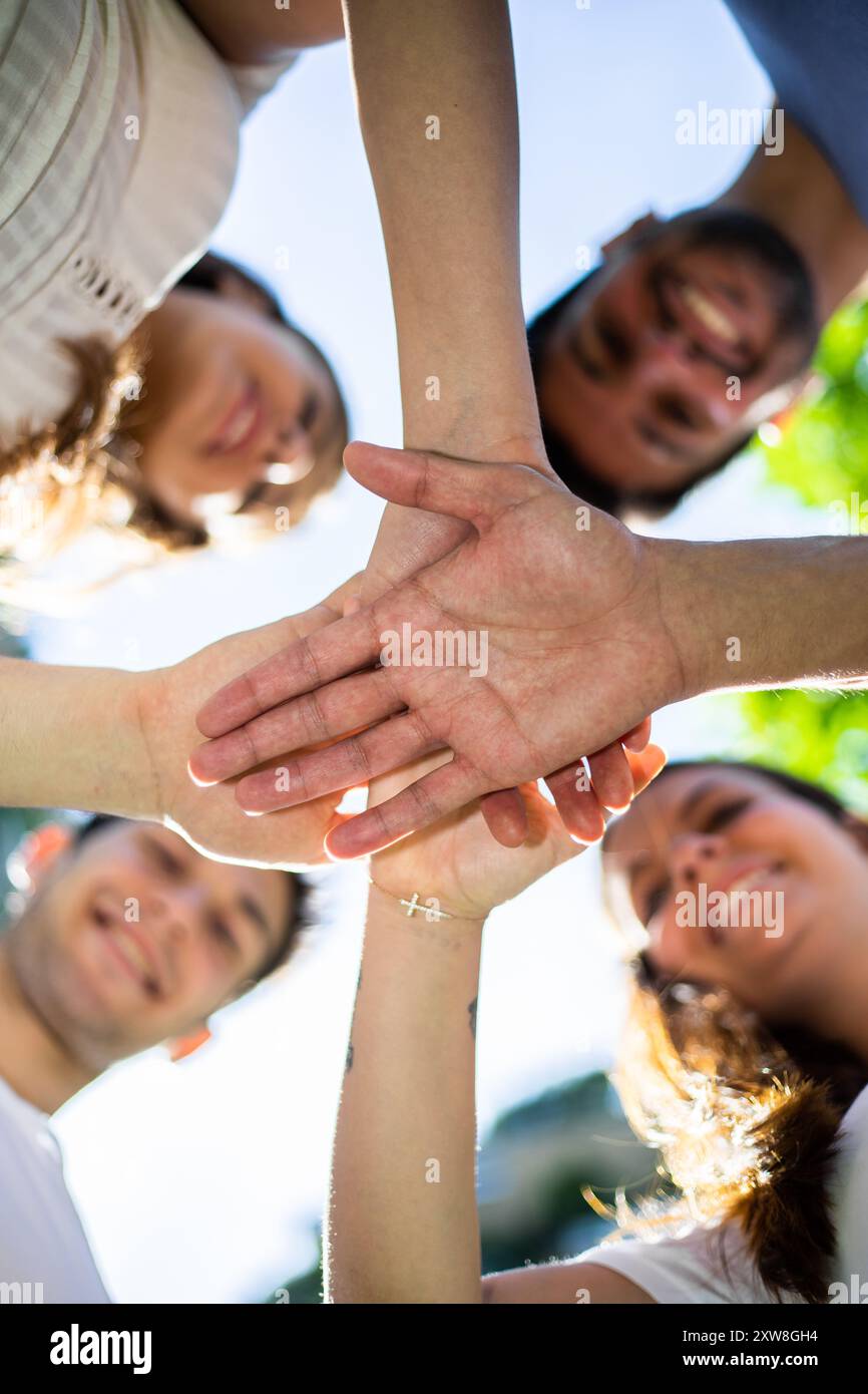 Diverse group smiling stacking hands hi-res stock photography and ...