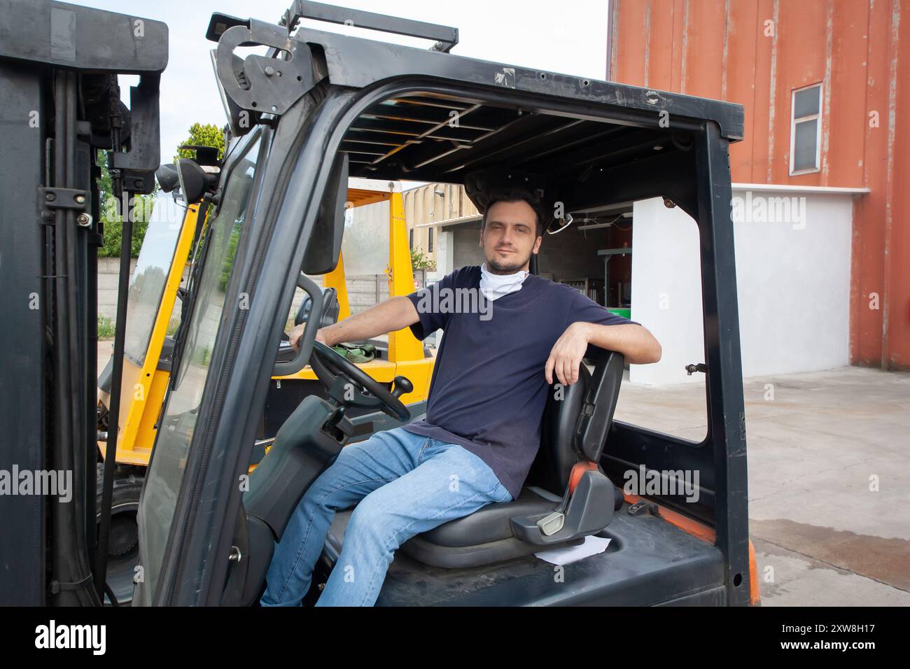 Worker operating an industrial forklift in a facility Stock Photo - Alamy