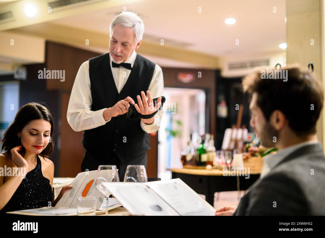 Waiter taking orders in a restaurant Stock Photo - Alamy