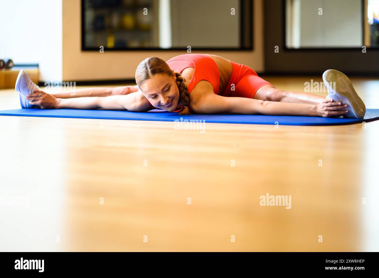 Woman in workout attire performs hi-res stock photography and images ...