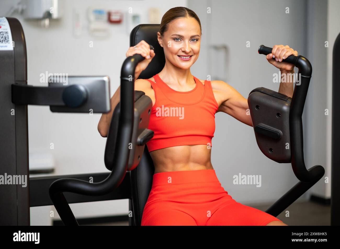 Woman using weightlifting equipment gym hi-res stock photography and ...