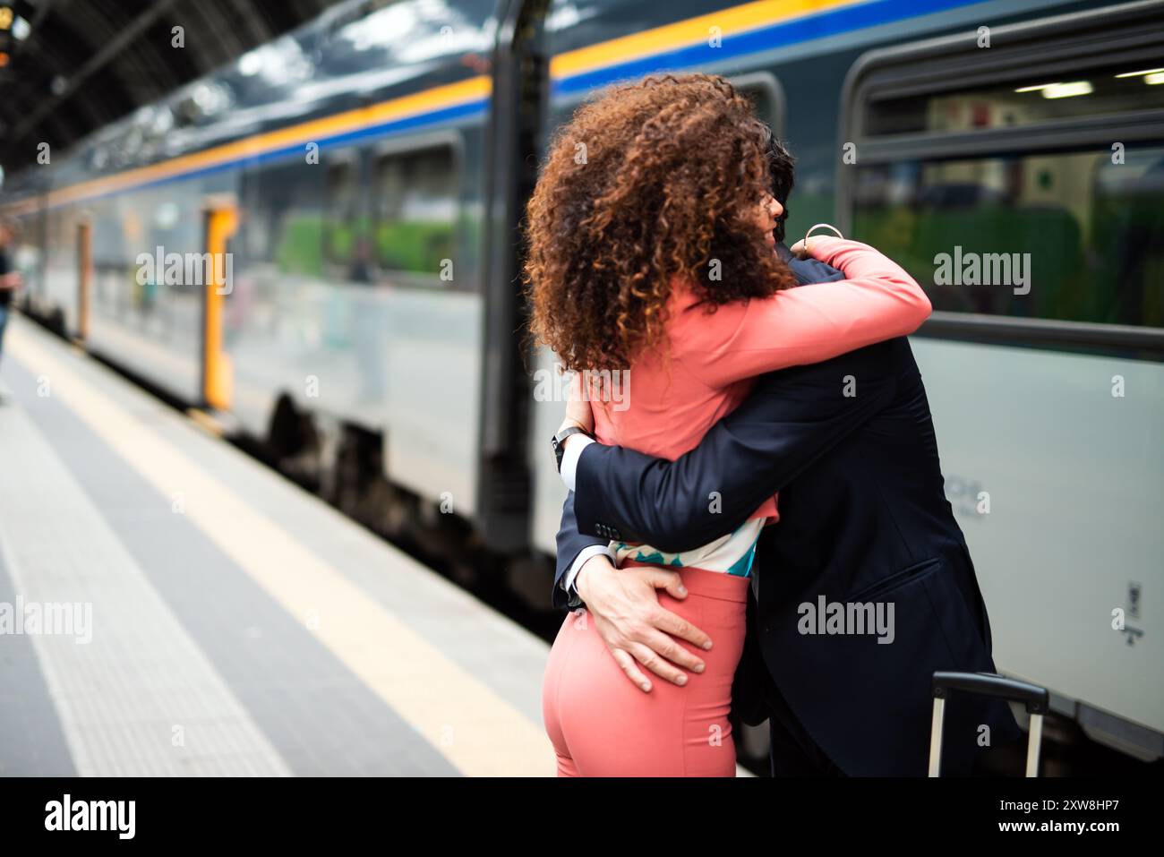 Beautiful couple hugging after long separation Stock Photo - Alamy