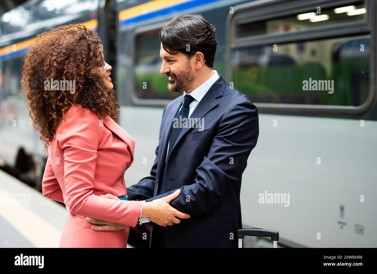 Beautiful couple hugging after long separation Stock Photo - Alamy
