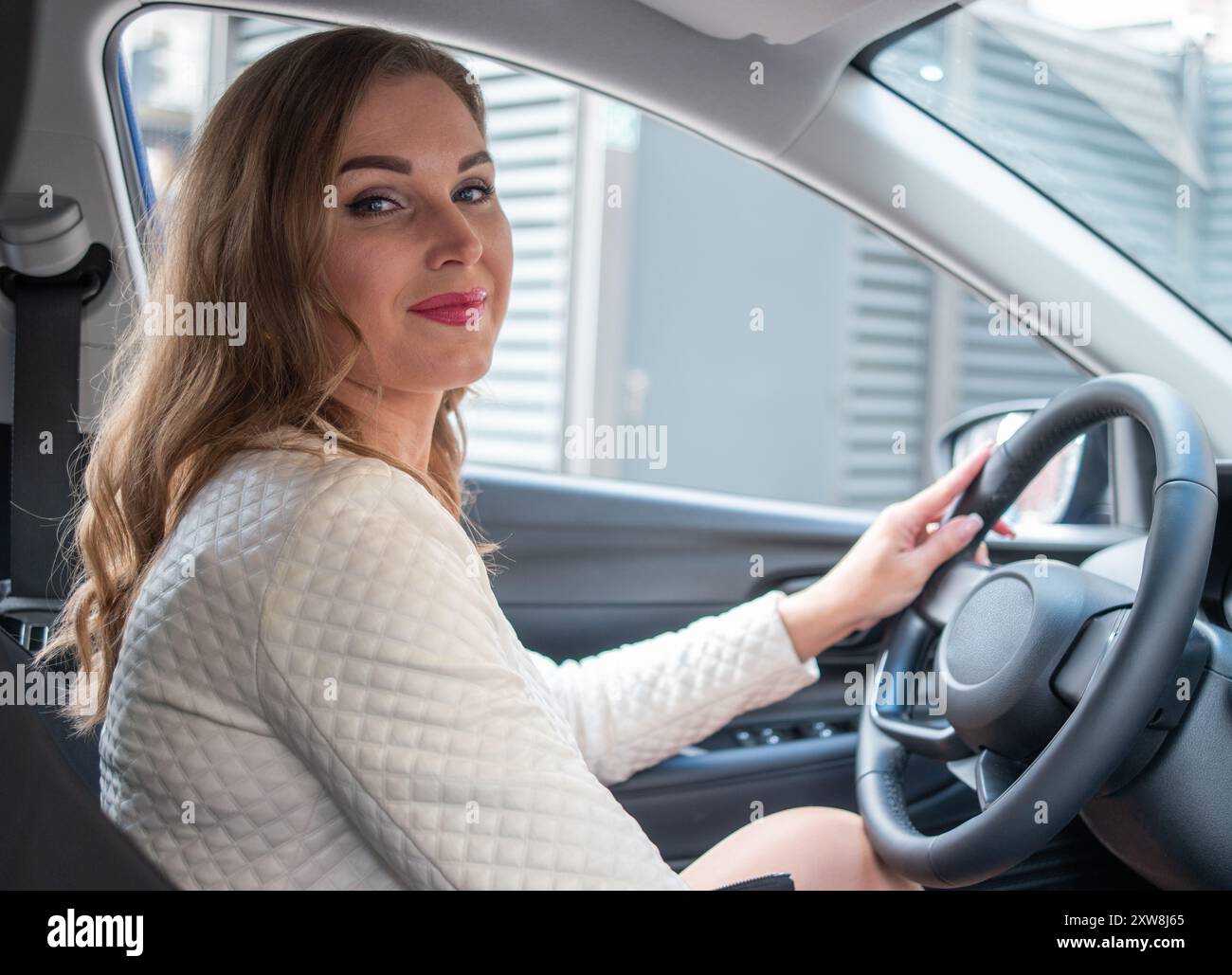 Young woman driving her car Stock Photo - Alamy