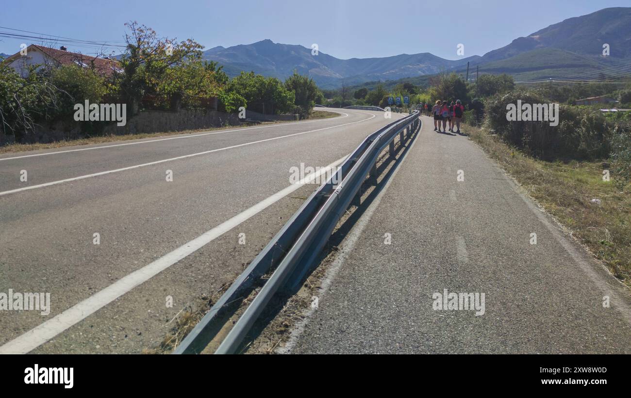 Segregated cycle lane running parallel to a local road. Pedestrians ...