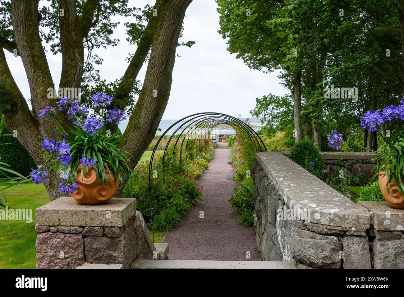 Castle pathway with trees and plants Stock Photo - Alamy