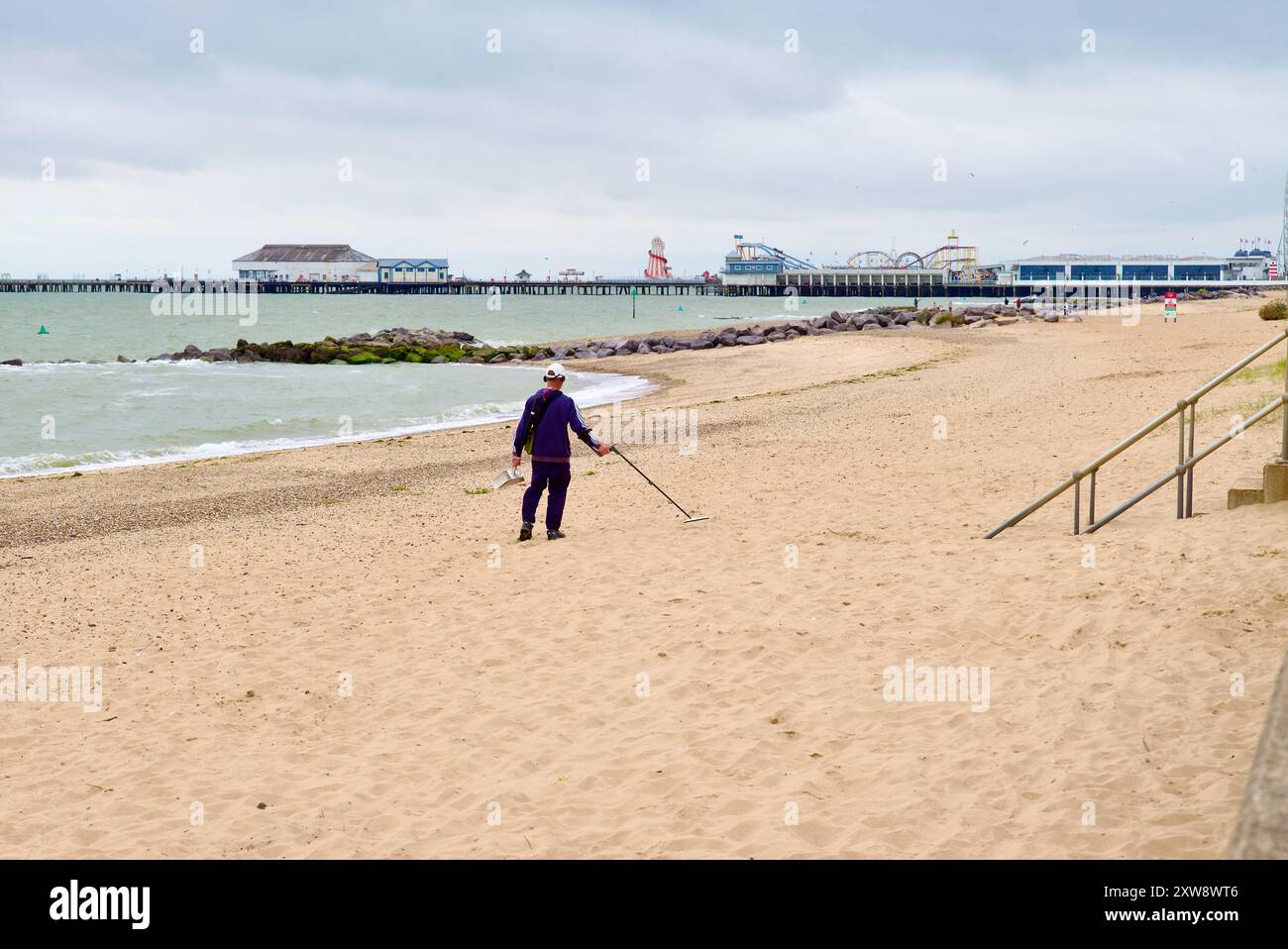 Metal detectorist scanning the beach at Clacton on Sea Essex united ...