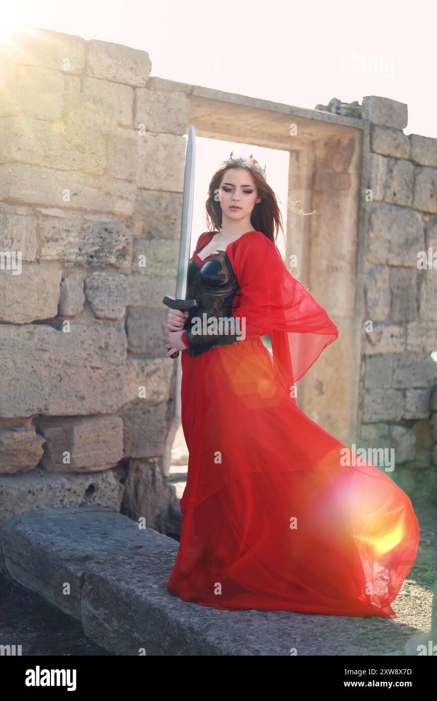 Medieval woman with red hair as a warrior with war paint with sword in ...