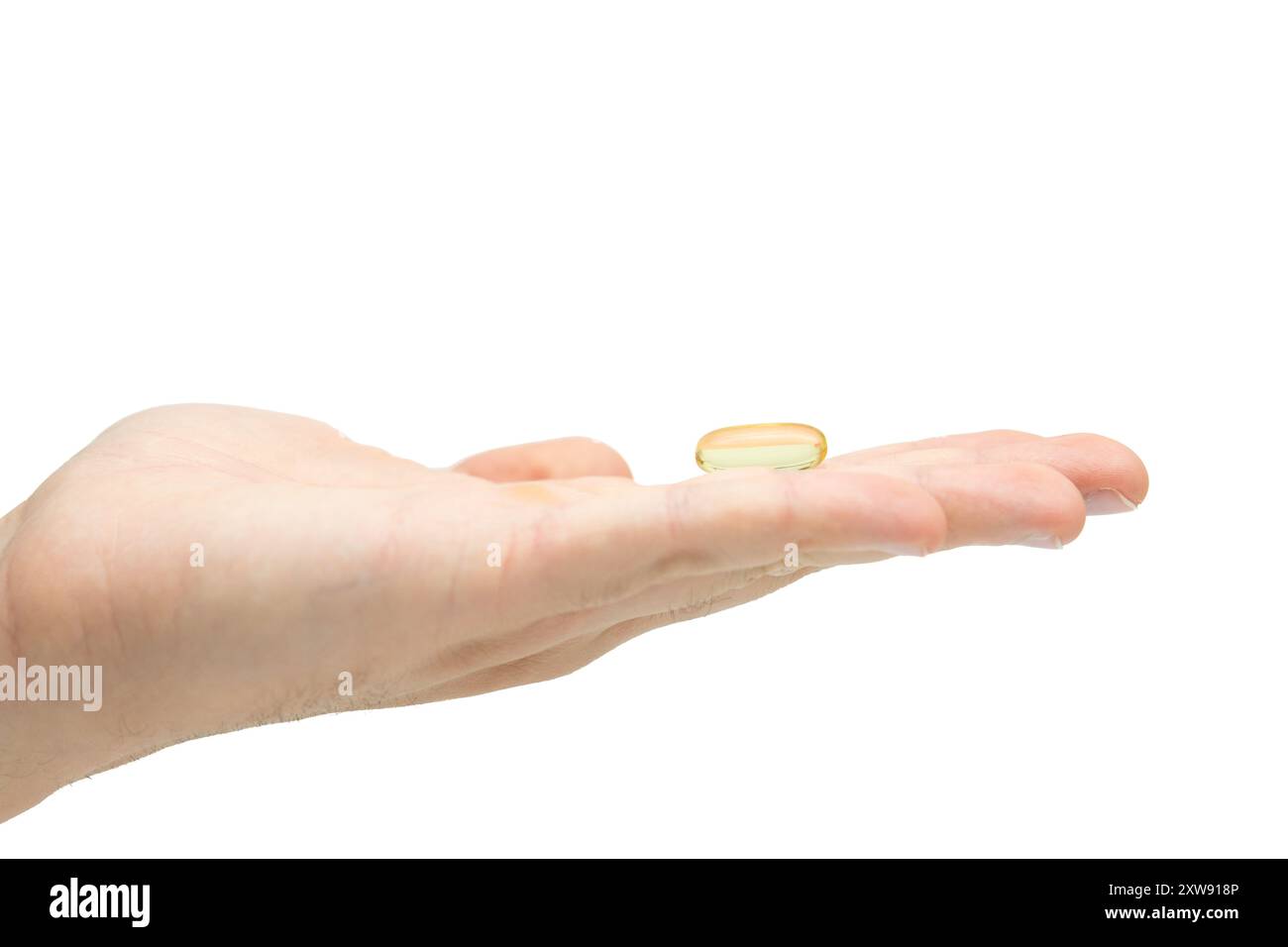 Male hand holding omega 3 soft gel capsule isolated on white background ...