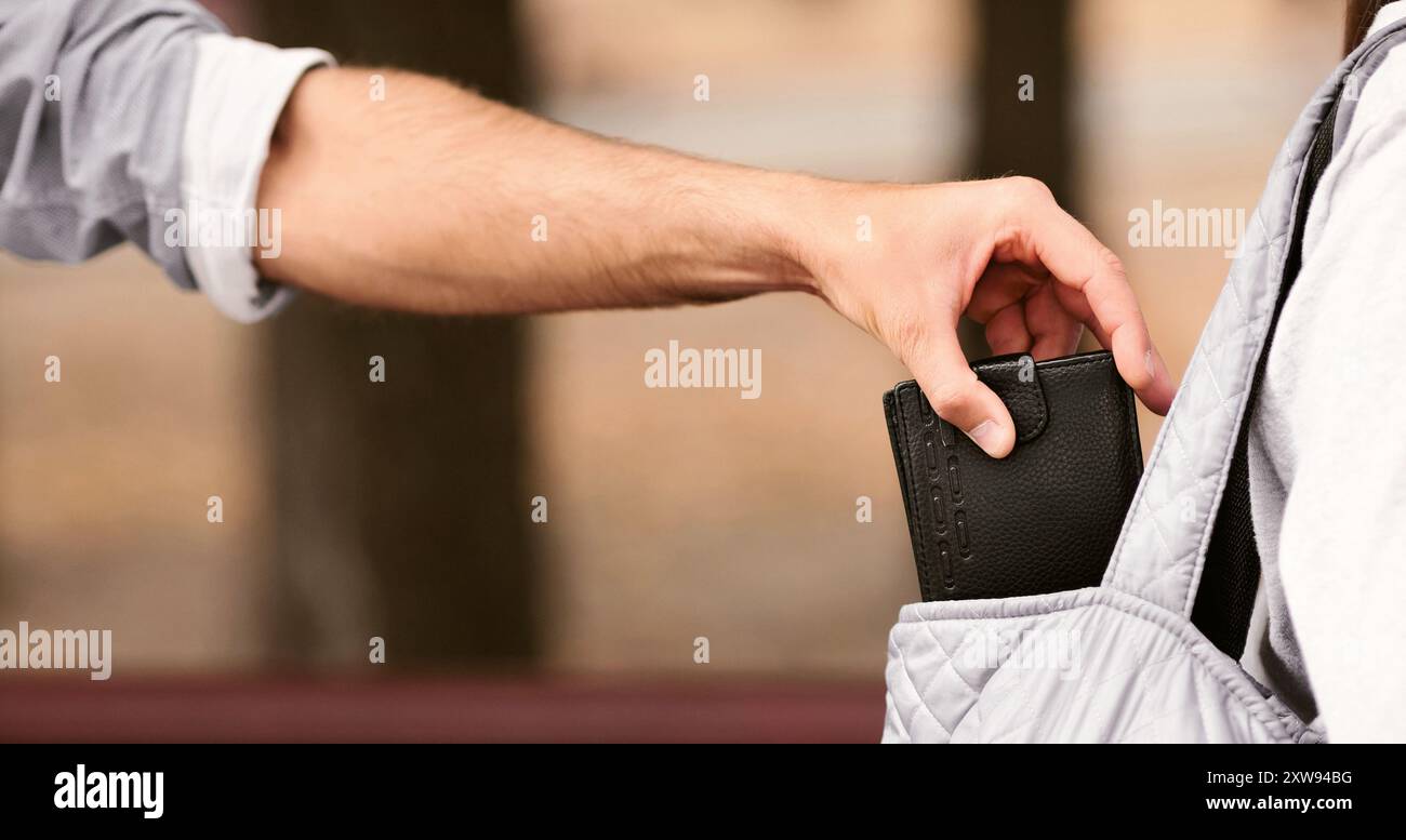 Pickpocket thief stealing wallet from woman handbag Stock Photo - Alamy