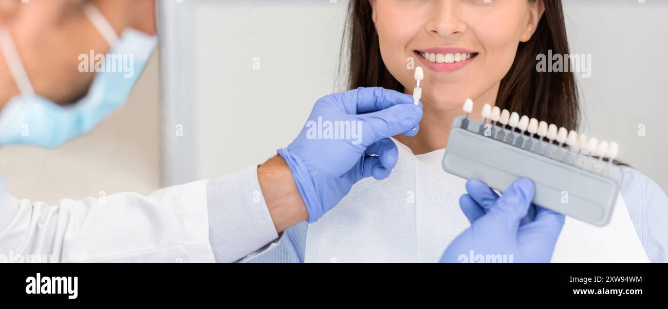 Dentist applying sample from tooth scale to smiling patient teeth Stock ...