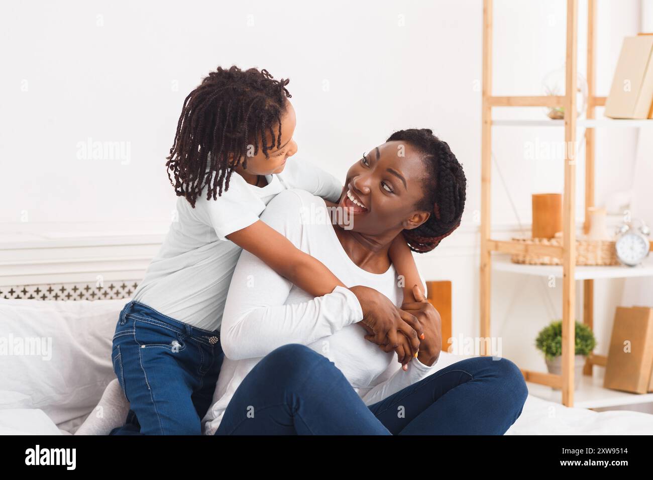 African american family cuddling in the bed Stock Photo - Alamy
