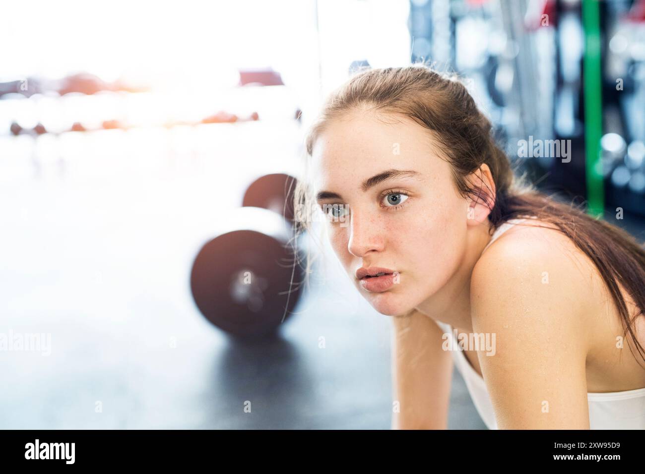 Young fitness girl with dental braces feeling exhausted after hard ...