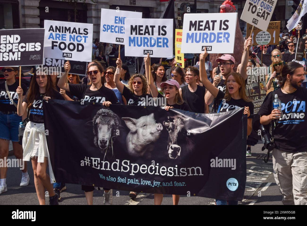 Protesters hold an 'End speciesism' banner and 'meat is murder ...