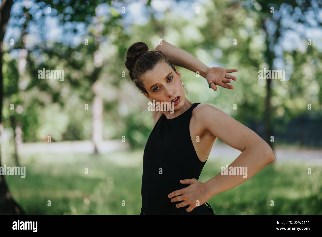 Lovely girl dancing in nature, female dancer performing modern dance in a lush green park Stock ...