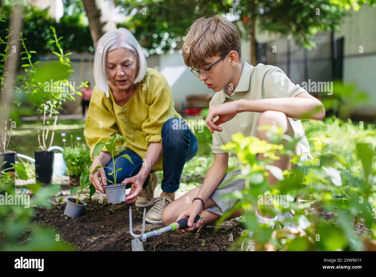 Teacher and young schoolboy during outdoor sustainable education ...