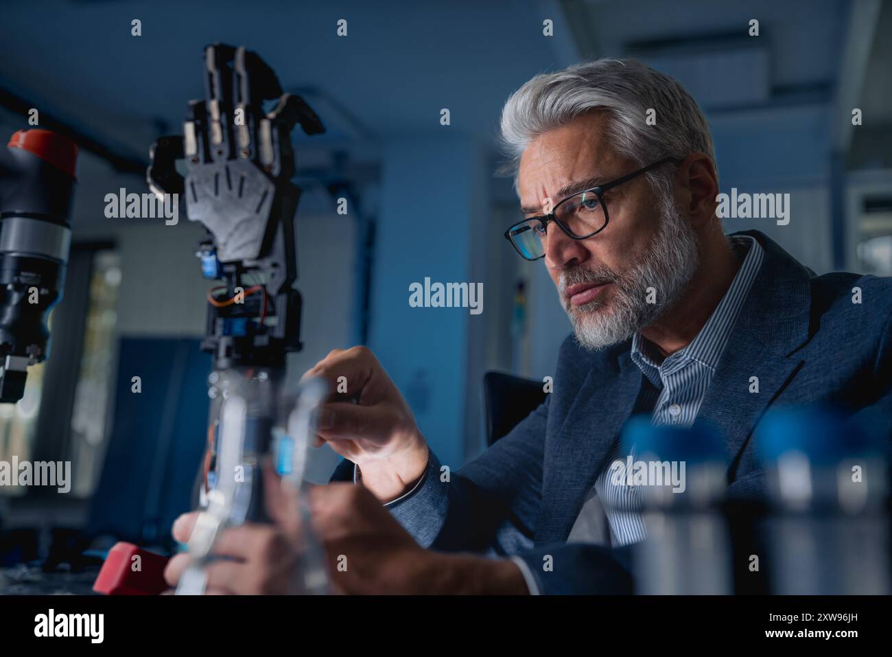 Robotics engineer adjusting, calibring robotic prosthetic hand. Concept ...