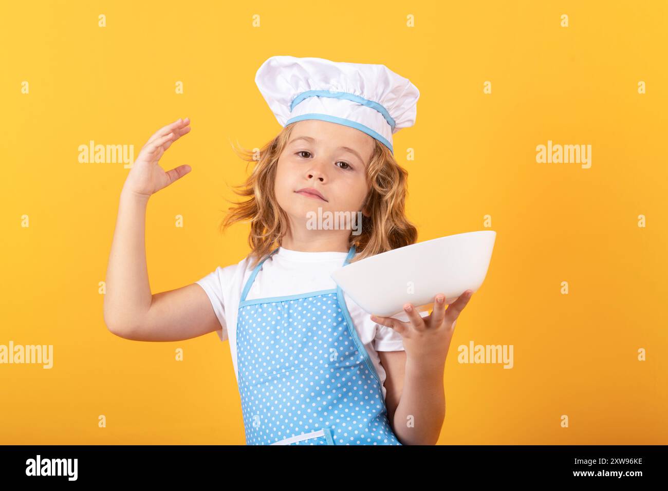 Funny kid chef cook with kitchen plate, studio portrait. Child cooking ...