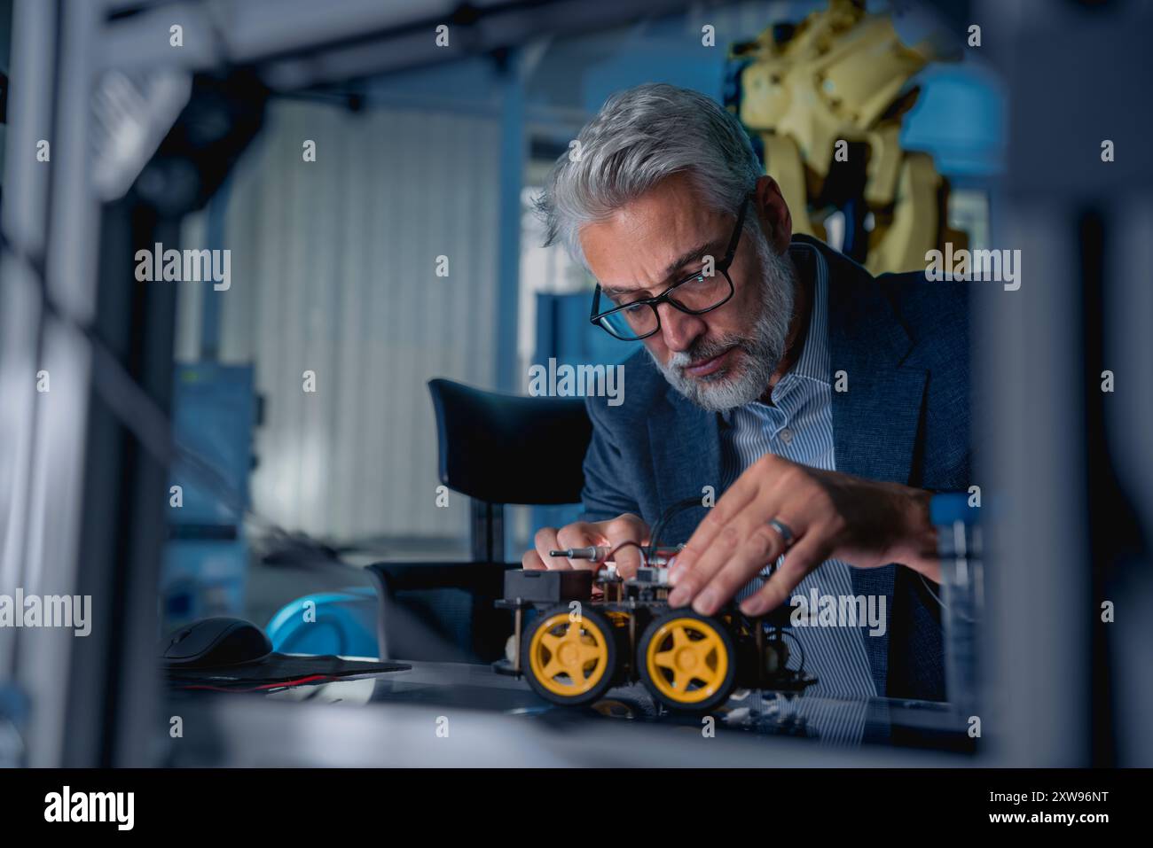 Automation, robotics engineer assembling robotic car prototype for ...