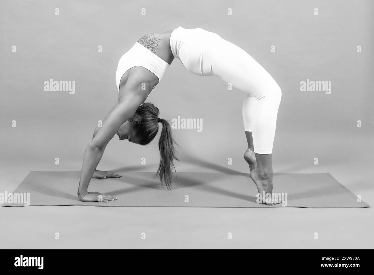 Girl stretching, doing bridge pose. Sportive girl, during exercises on ...