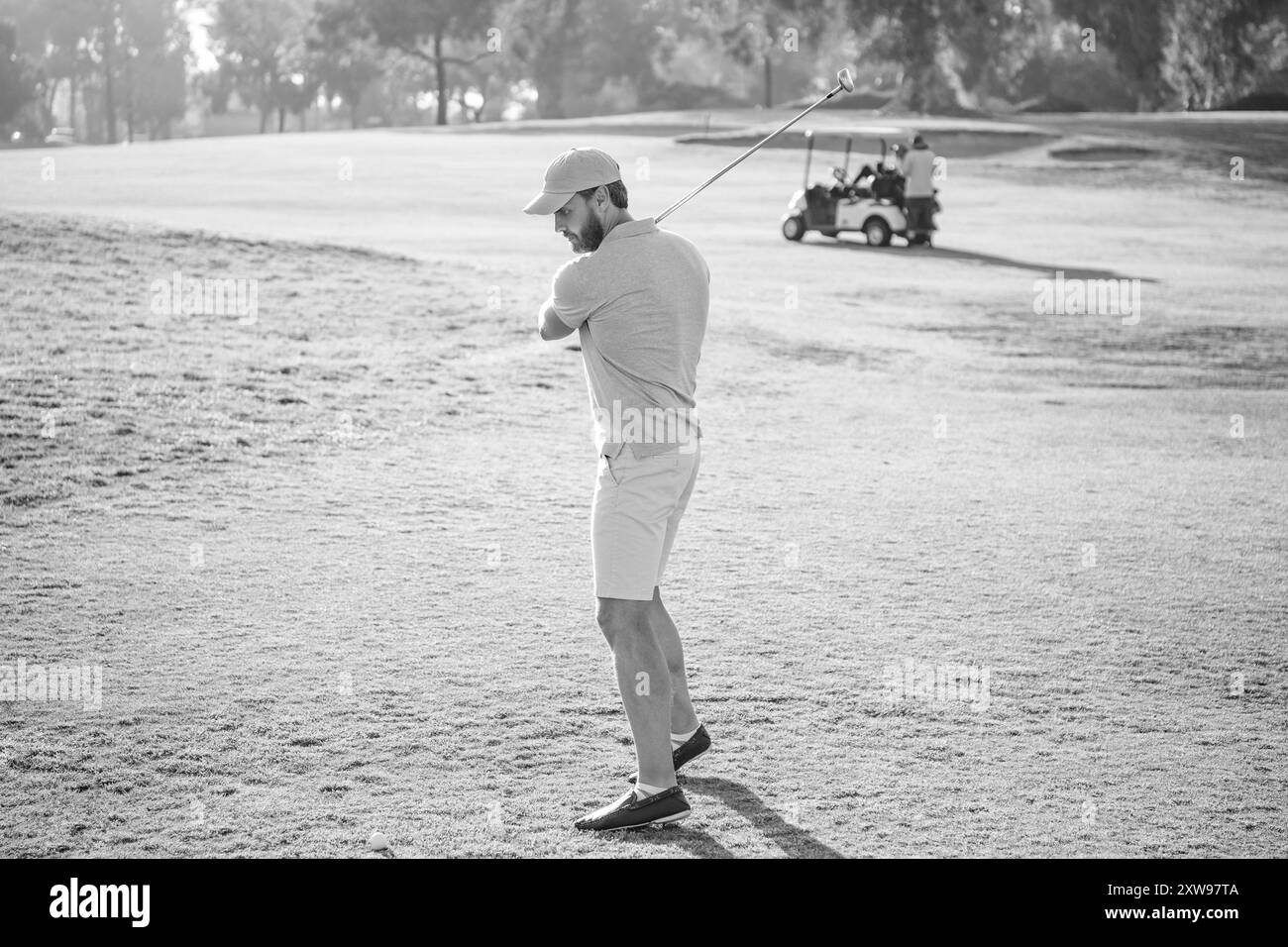 full length portrait of golfer in cap with golf club. people lifestyle ...