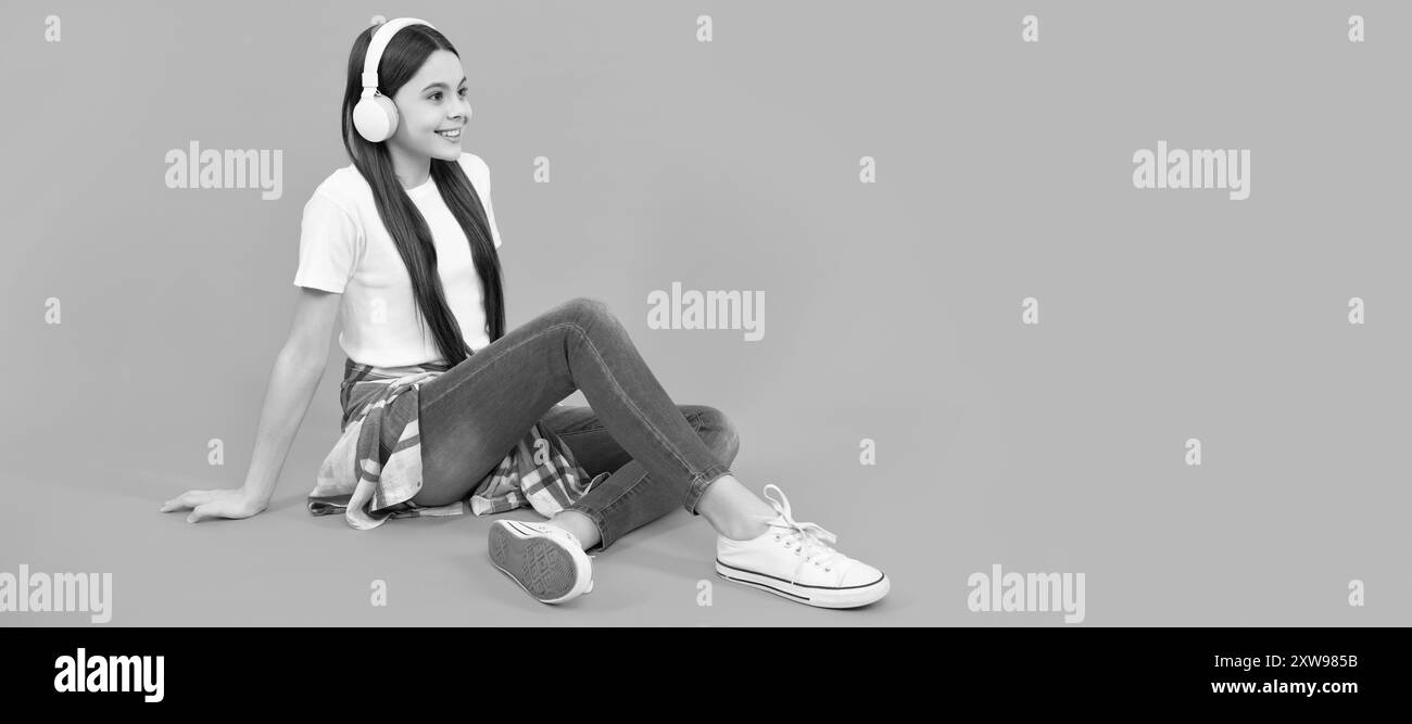 happy teen girl listen to music in wireless headphones. Child portrait ...