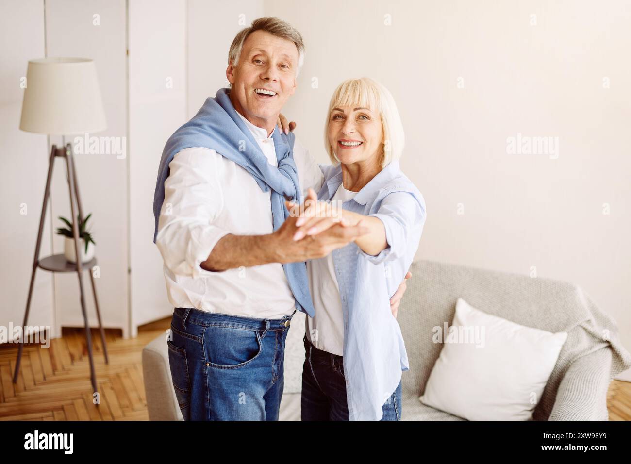 Elderly couple dancing together in the living room Stock Photo - Alamy
