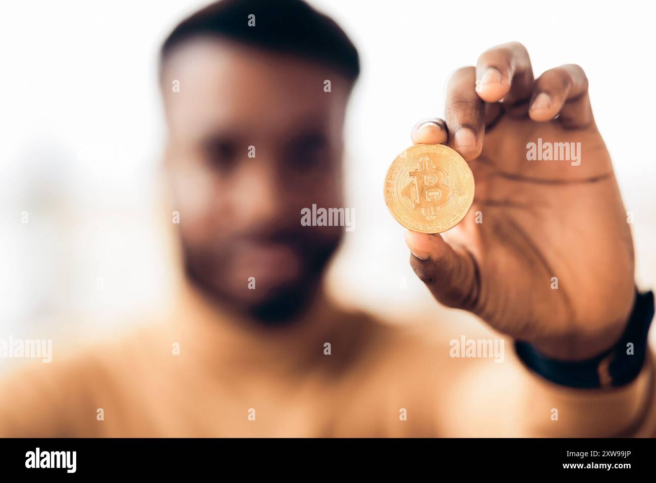 Unrecognizable african american guy showing golden bitcoin Stock Photo ...