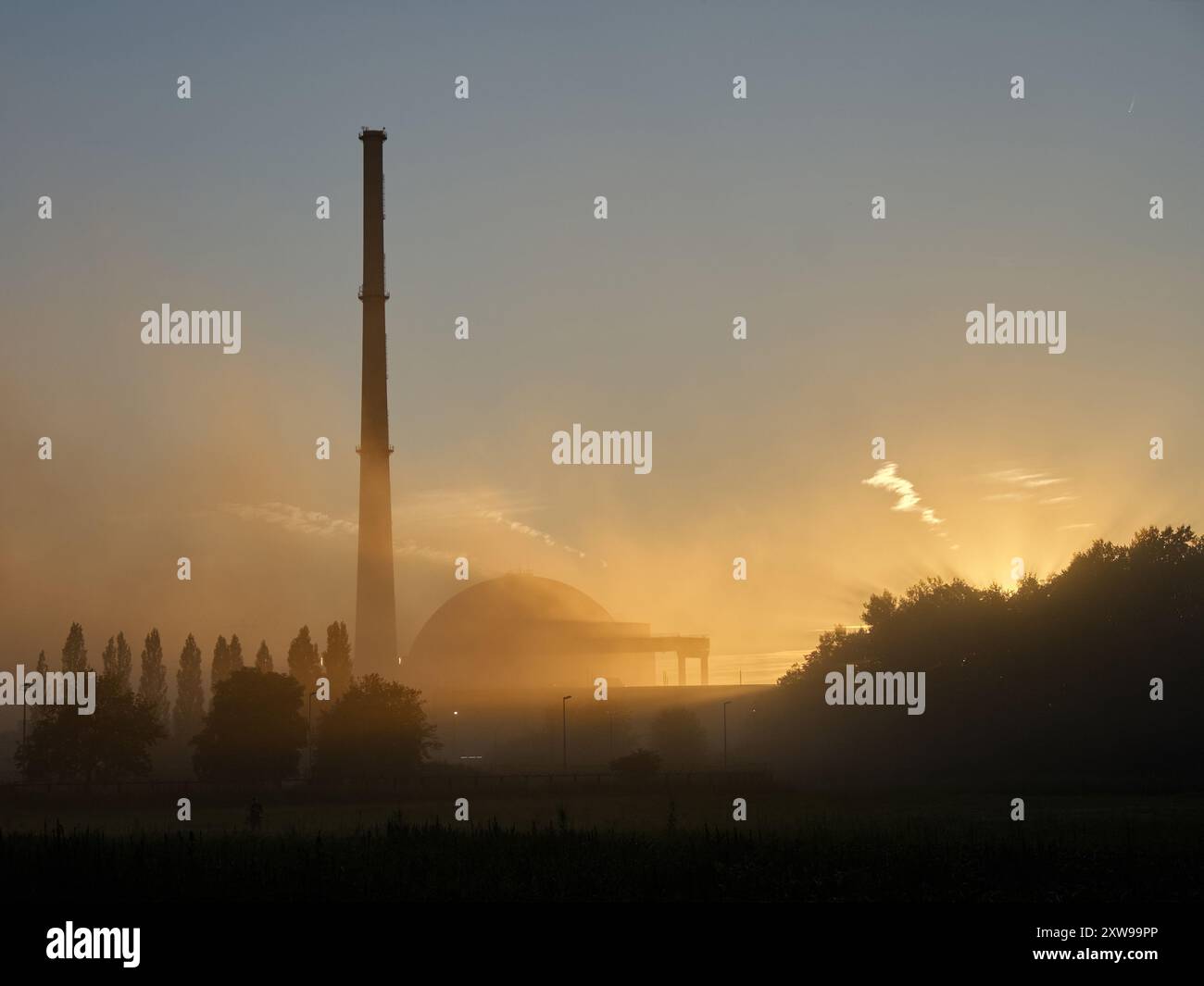 Pipe and nuclear reactor dome in dusty sunset rays after demolition of ...
