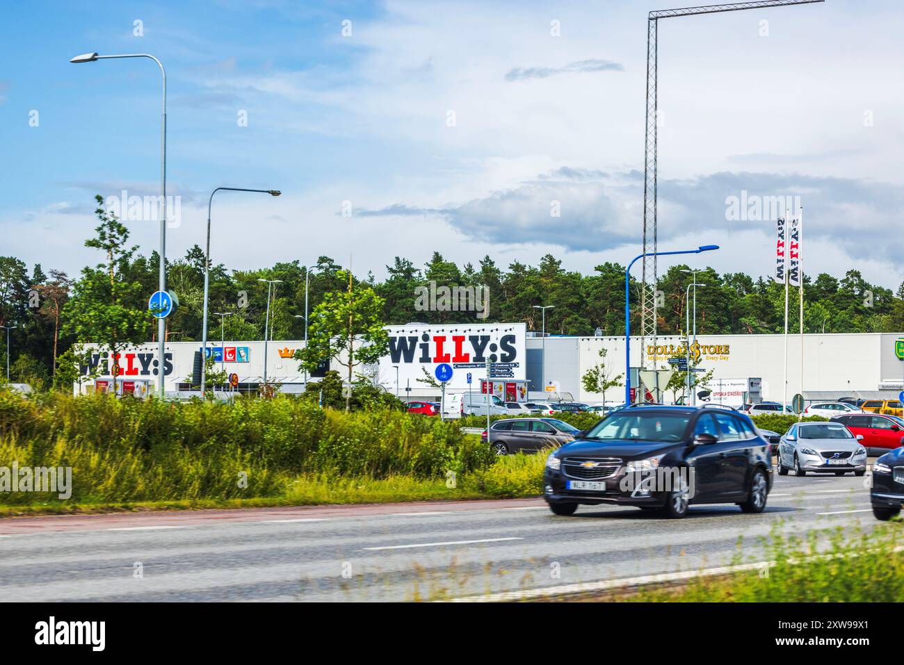 View of shopping center with various retail stores, including "Willys ...