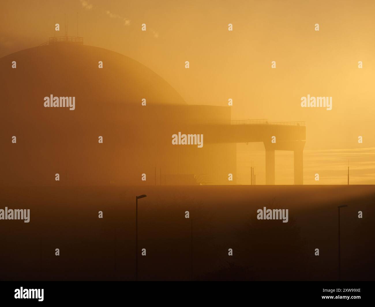 Nuclear reactor dome in dusty sunset rays with trees and lantern in ...