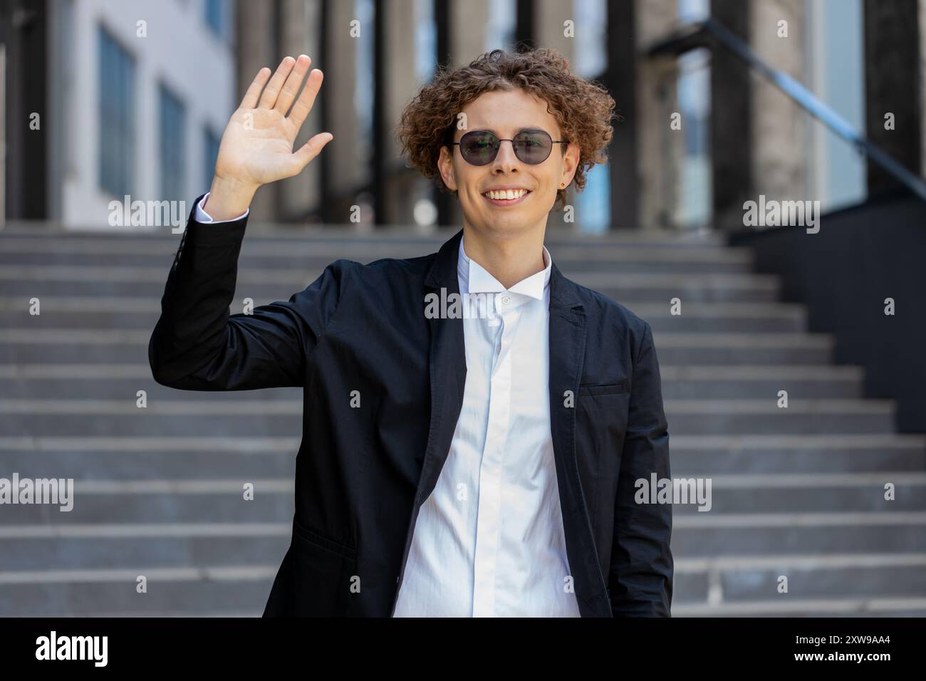 Hello. Caucasian businessman smiling friendly at camera, waving hands ...