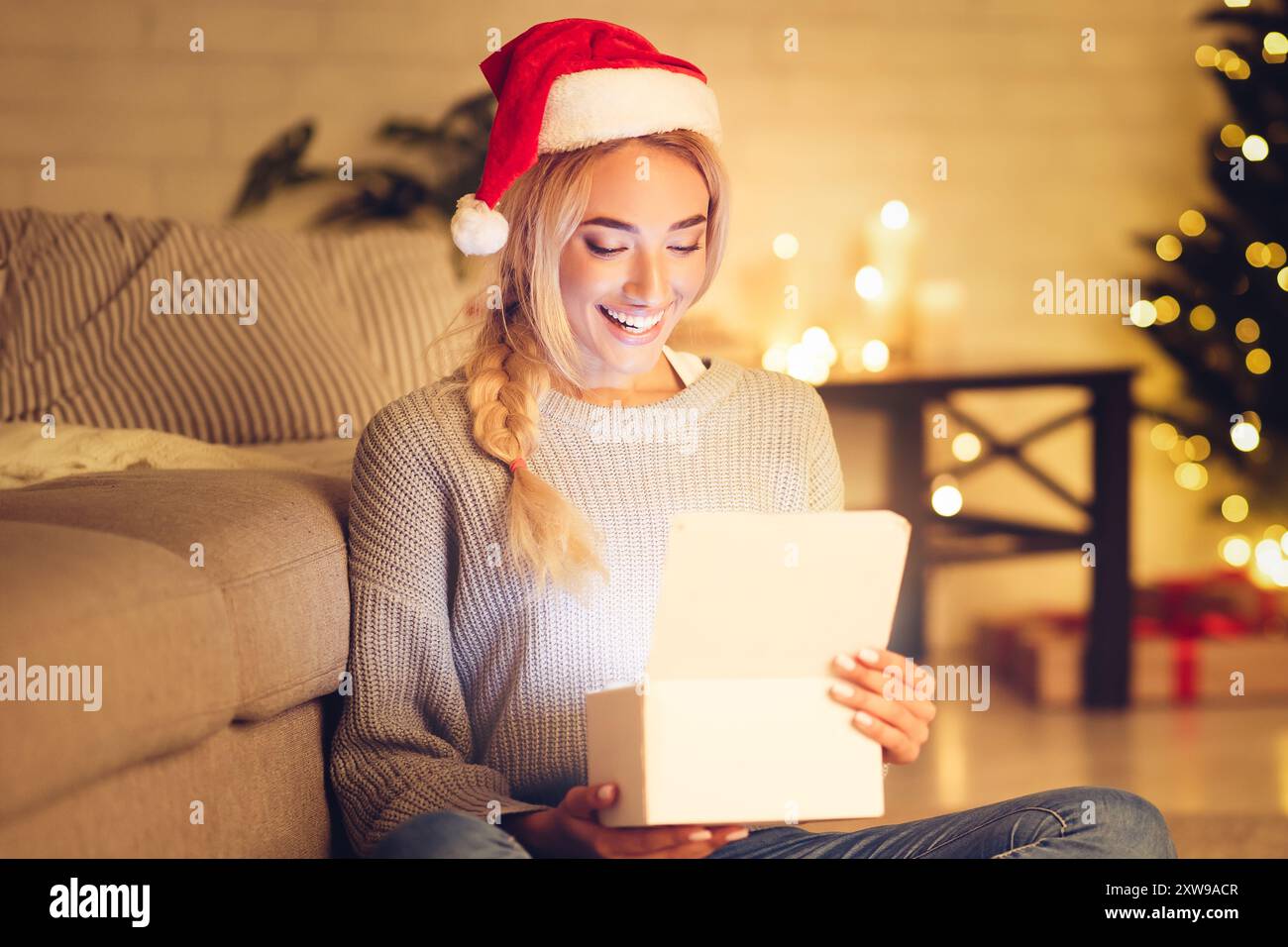 Christmas magic. Happy woman open gift box Stock Photo - Alamy