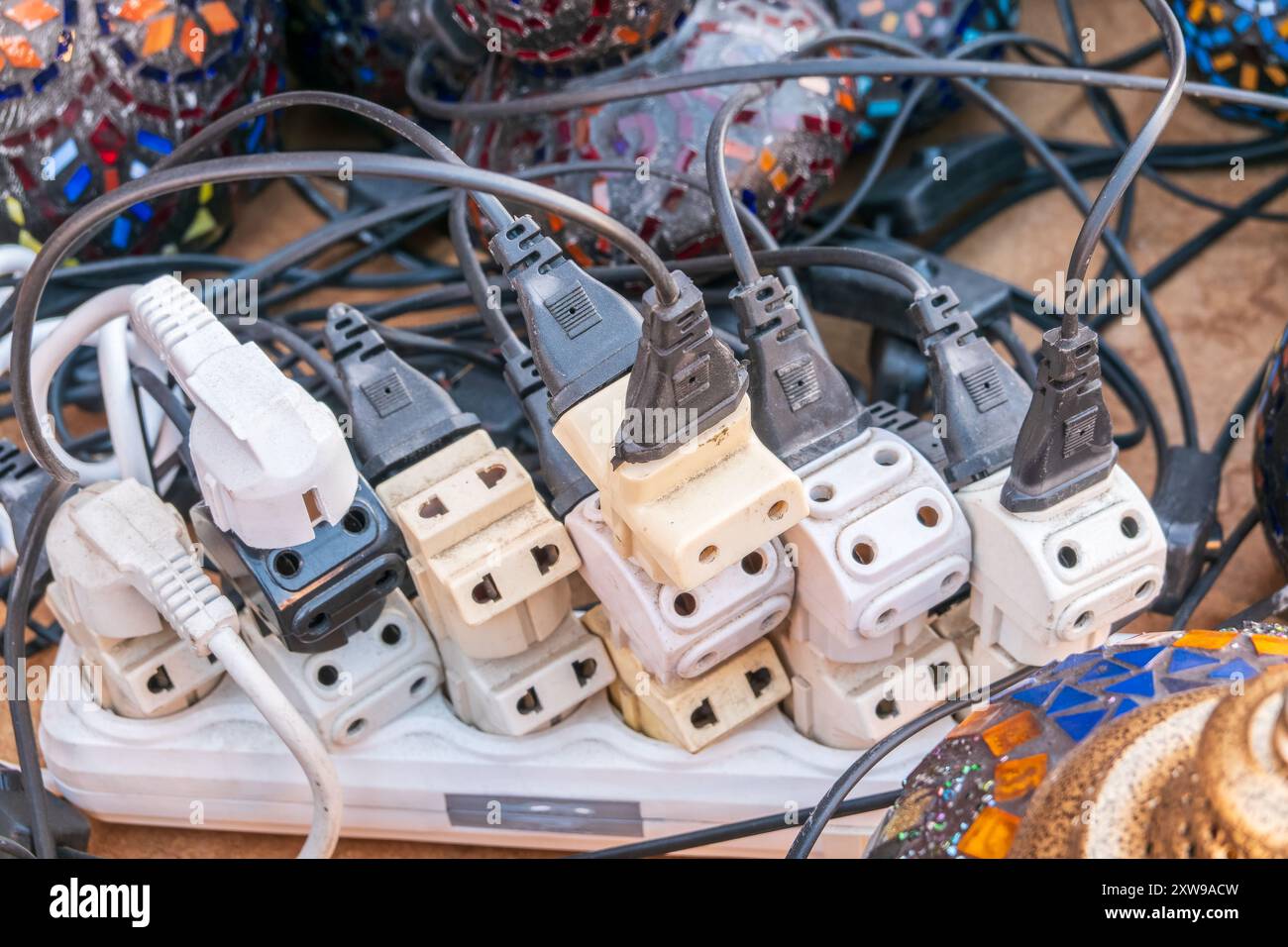 Old and damaged electric adapter power plug has many appliances are ...