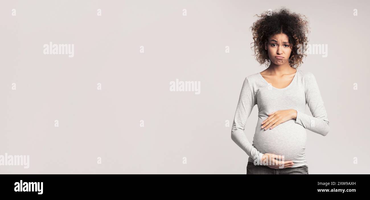 Hormones and mood changes. Sad expectant woman touching belly Stock ...