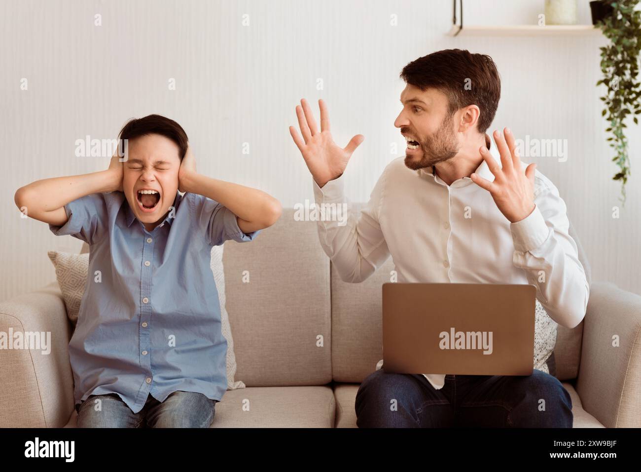 Father Shouting At Scared Son Sitting On Sofa Indoor Stock Photo - Alamy