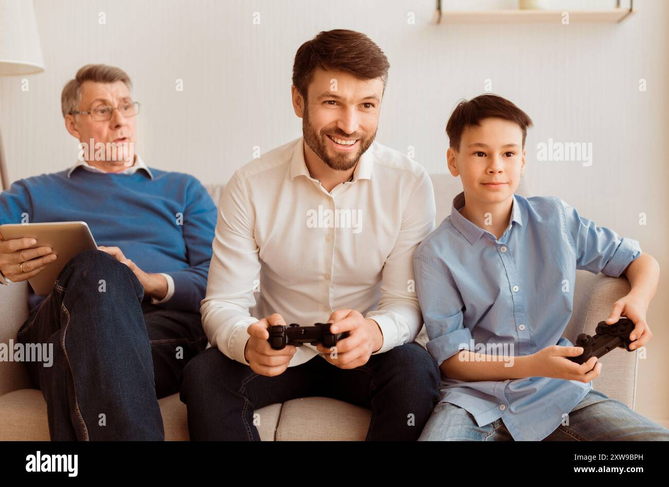 Man Playing Video Games With Son And Elderly Dad Indoor Stock Photo - Alamy