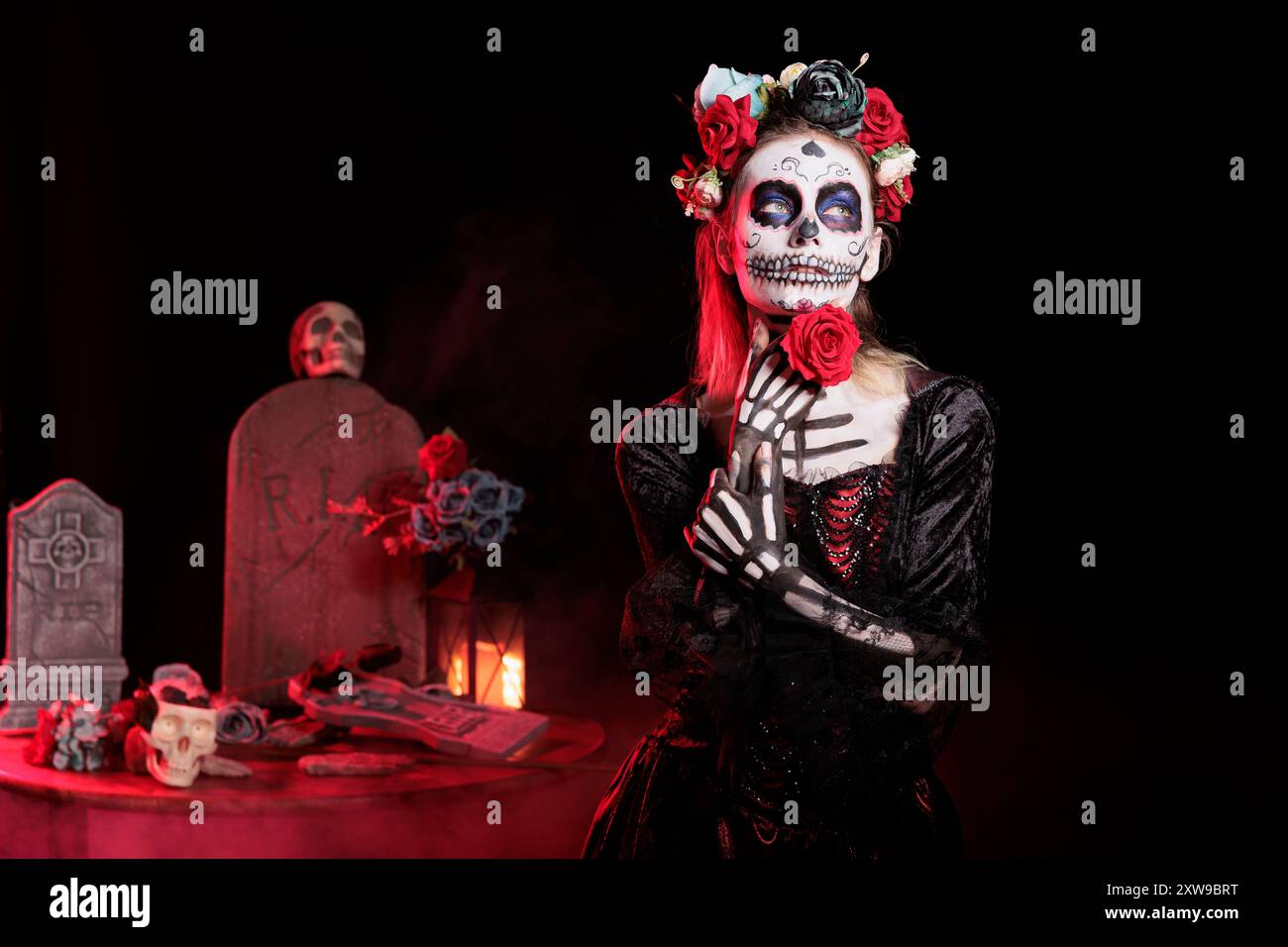 Woman using red rose for magic ritual in graveyard, celebrating Day of ...