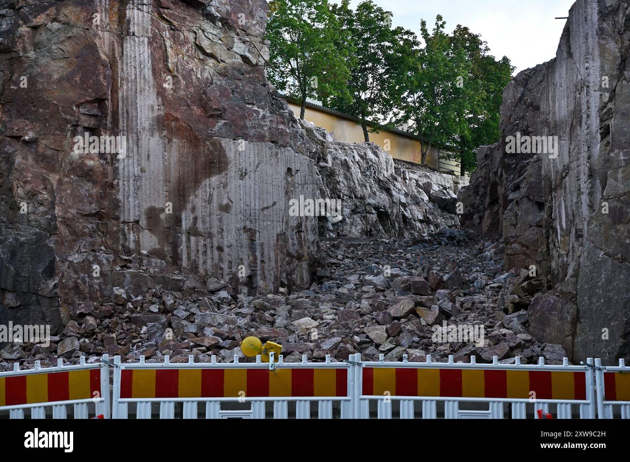 This image shows a rock excavation site, where a large exposed rock ...