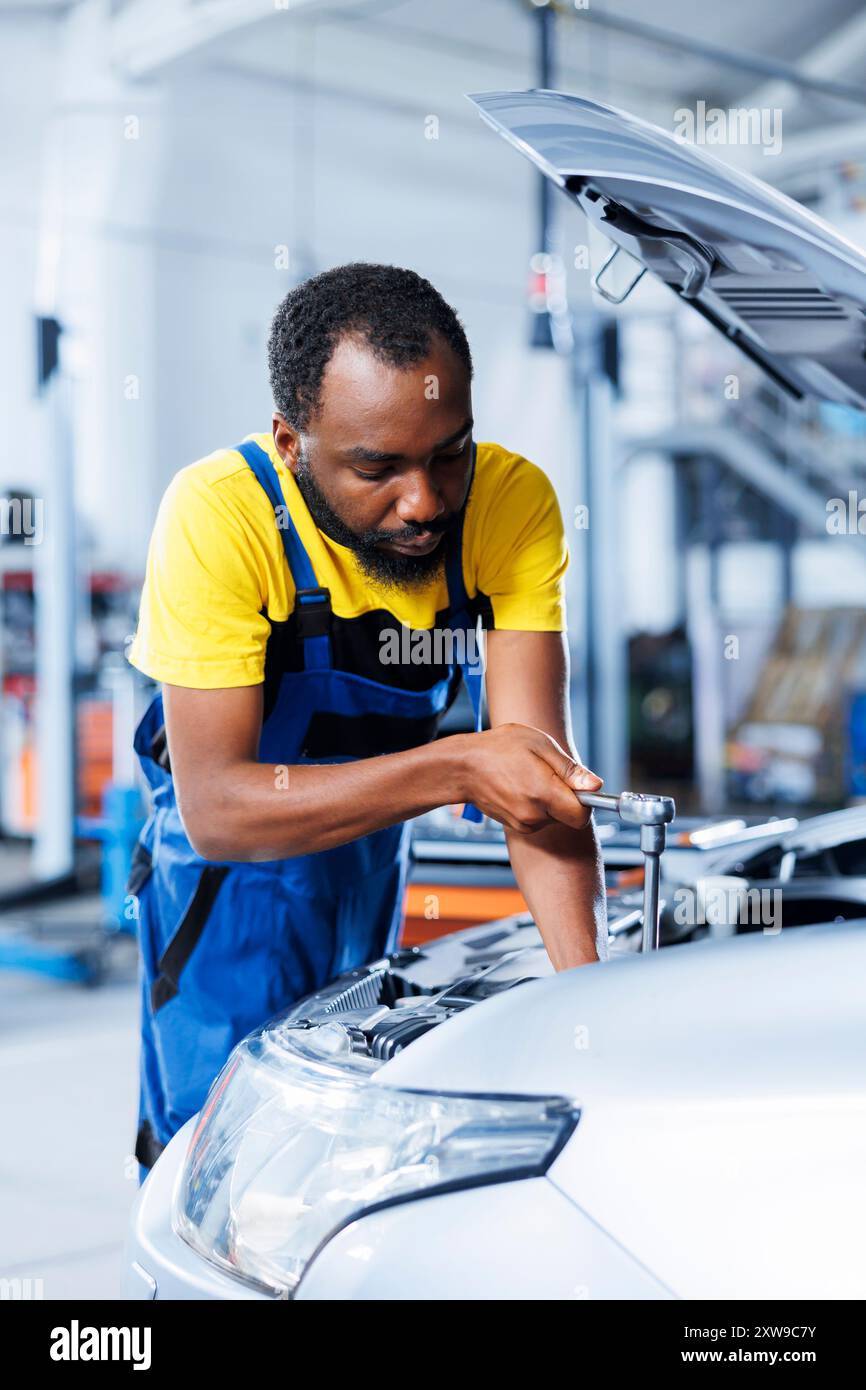 Engineer expertly examines car ignition system using advanced ...