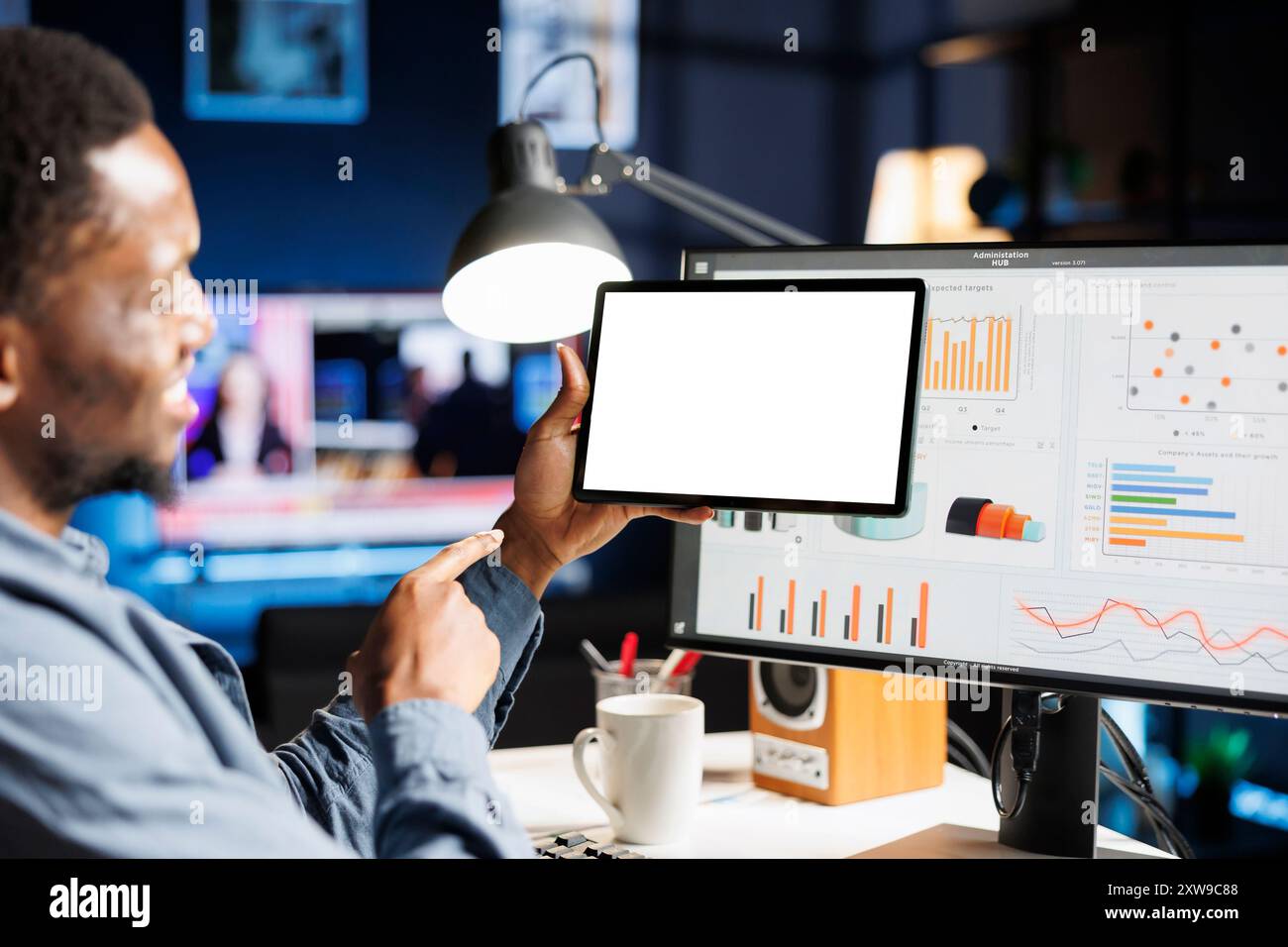 Freelancer checks tablet with white screen template, sitting at his ...