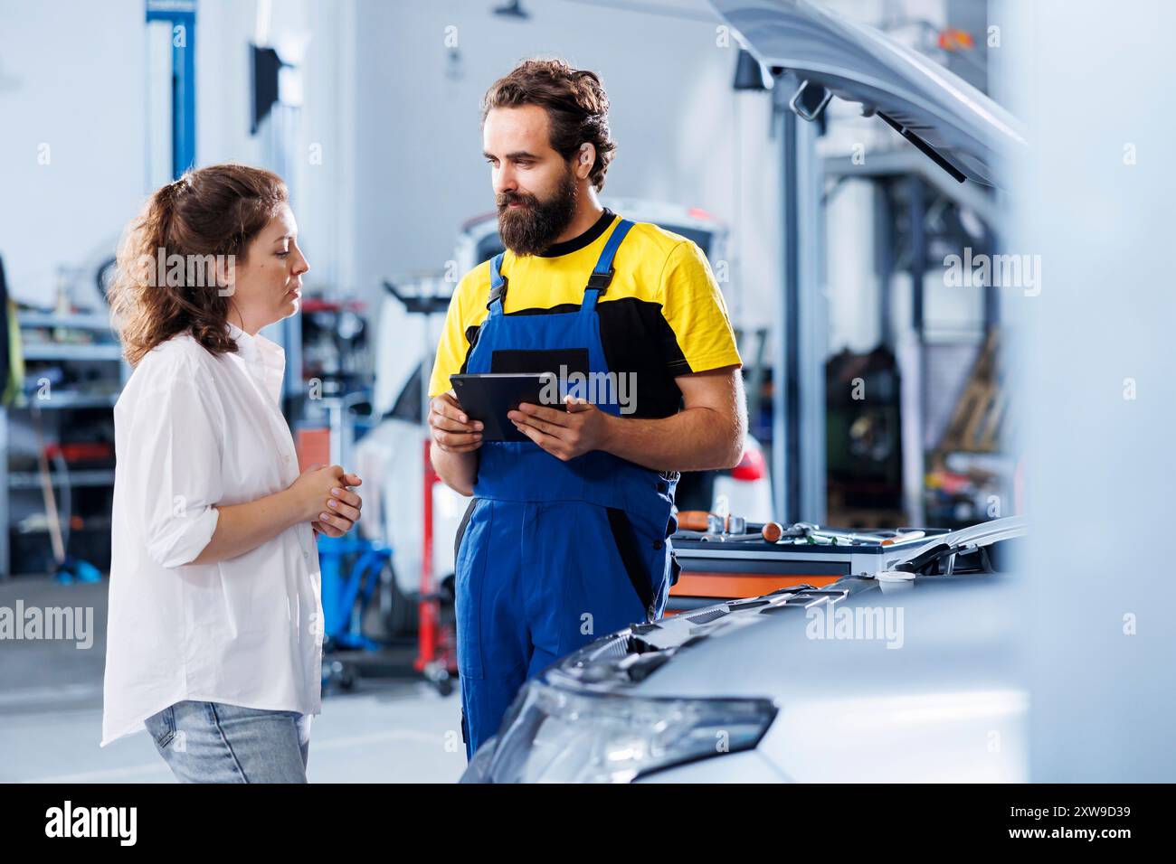 Repairman at auto repair shop conducts annual vehicle checkup ...