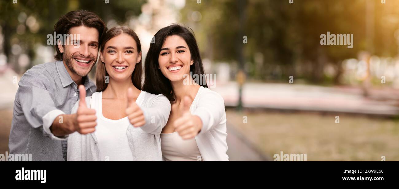 Three Happy Friends Gesturing Thumbs Up Standing Outdoor Stock Photo ...