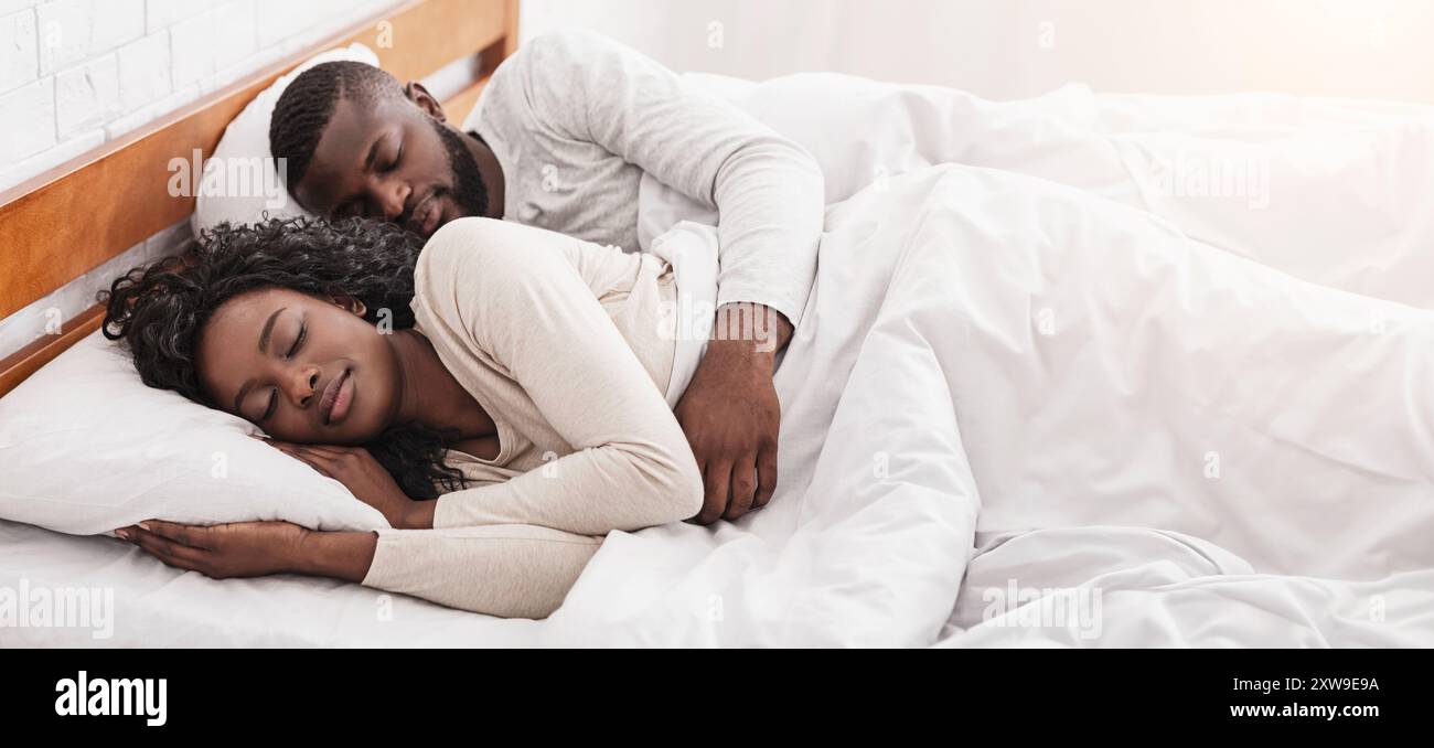 Young african american couple napping in bed together Stock Photo - Alamy
