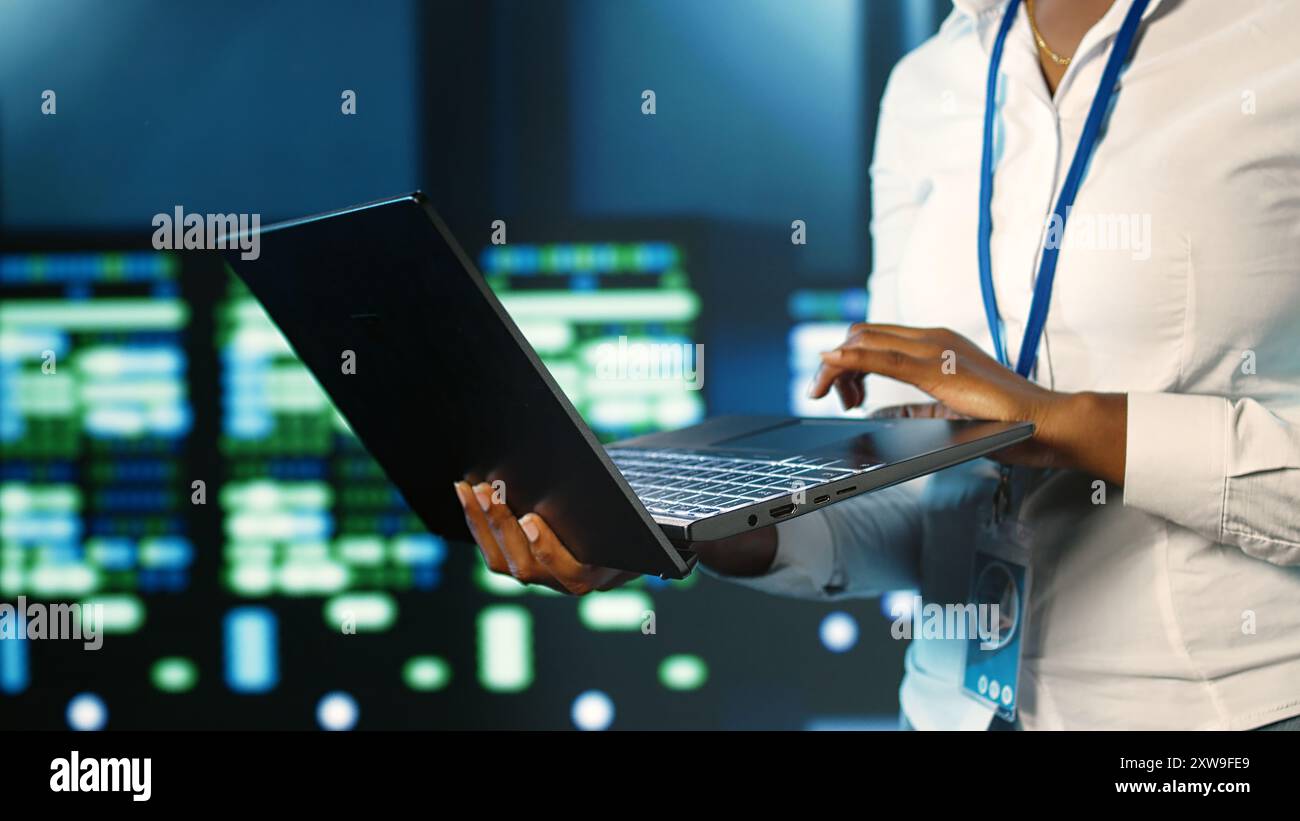 Employee strolling through data center hardware clusters providing ...