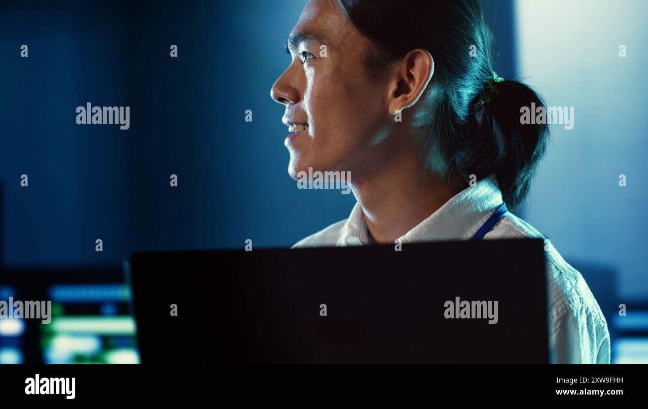 Close up shot of happy employee wandering around data center ...