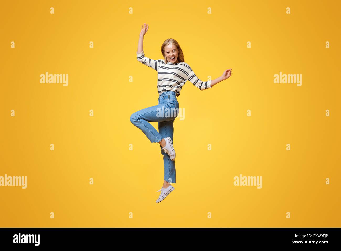 Positive beautiful teen girl jumping in air with hands up Stock Photo ...