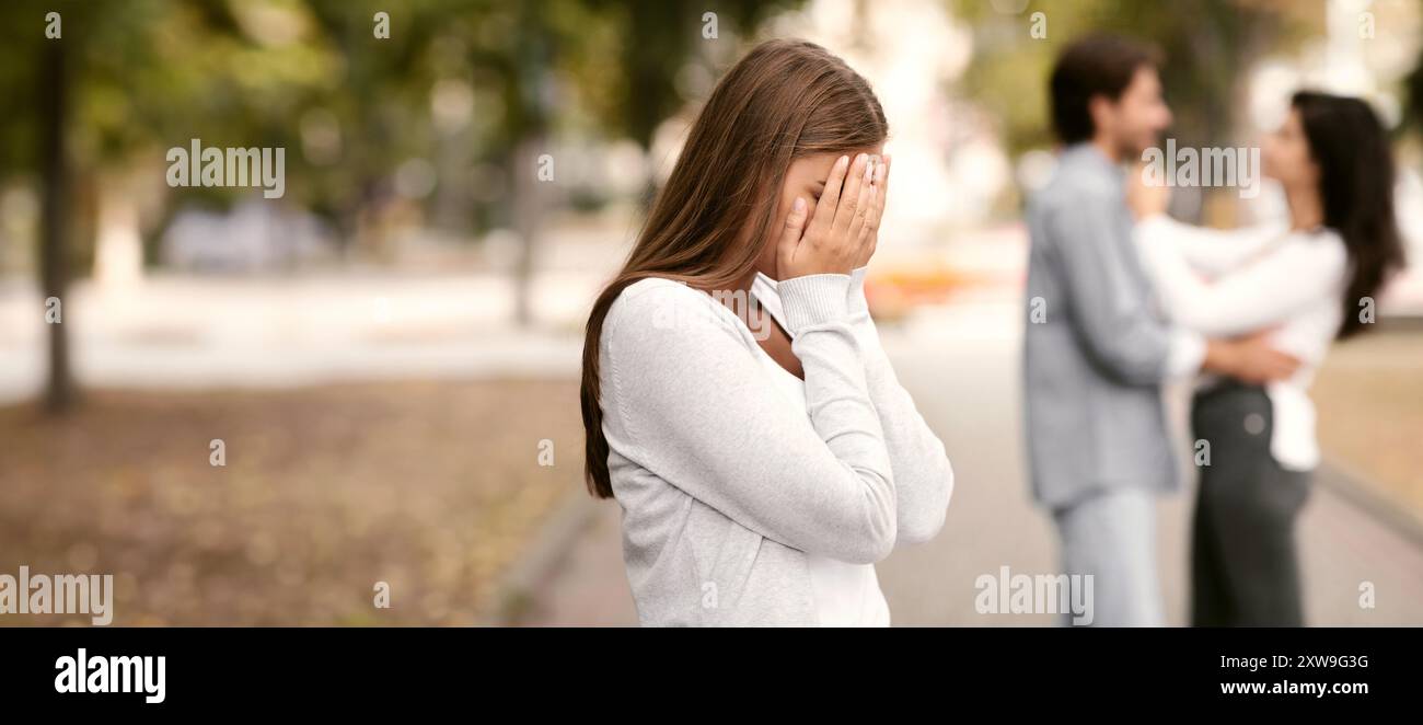 Upset woman crying, seeing her boyfriend with other girl Stock Photo ...
