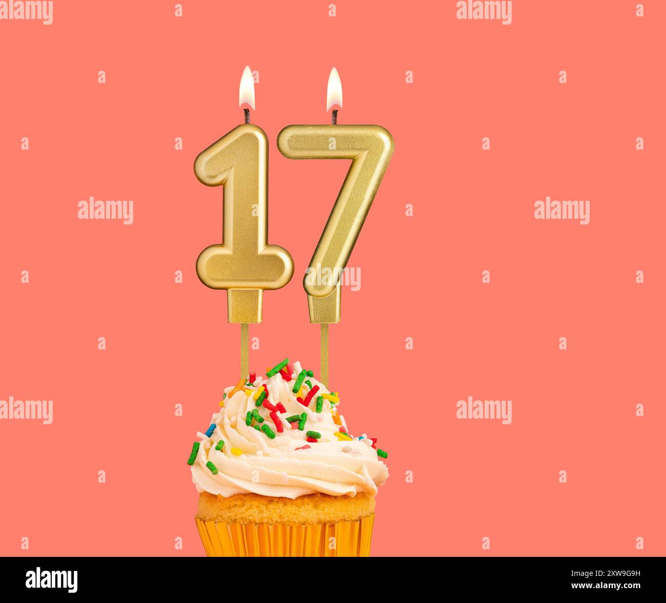 Birthday number 17 - Golden candle with cupcake Stock Photo - Alamy